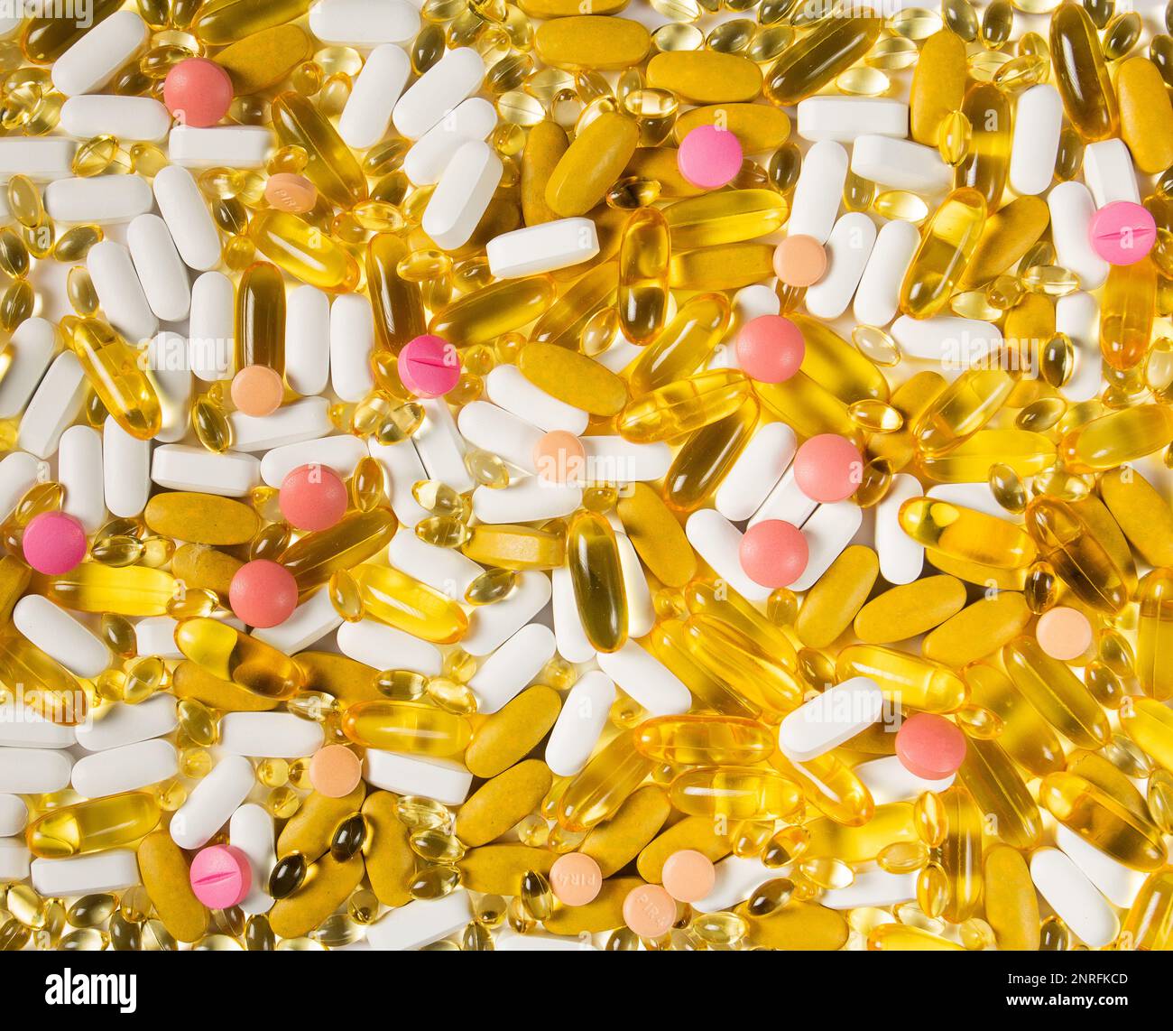 Flat lay, background of multi-colored medical pills and gel capsules ...
