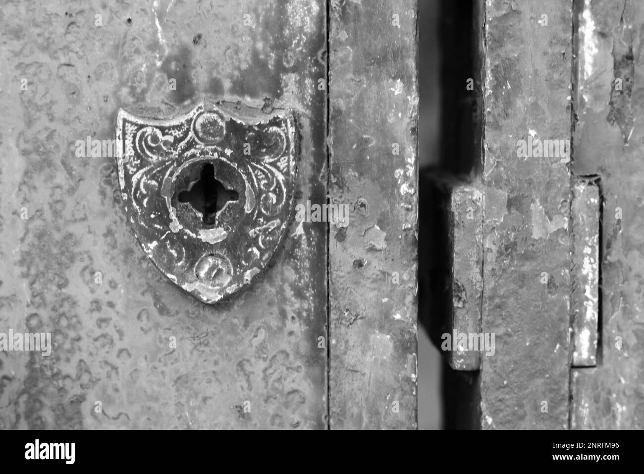 Vintage metal traditional medieval keyhole on an iron gate in a black ...