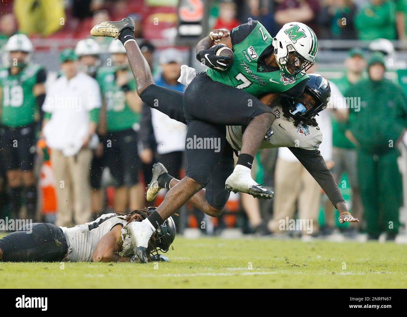 Marshall wide receiver Obi Obialo (7) is tackled by Central Florida ...