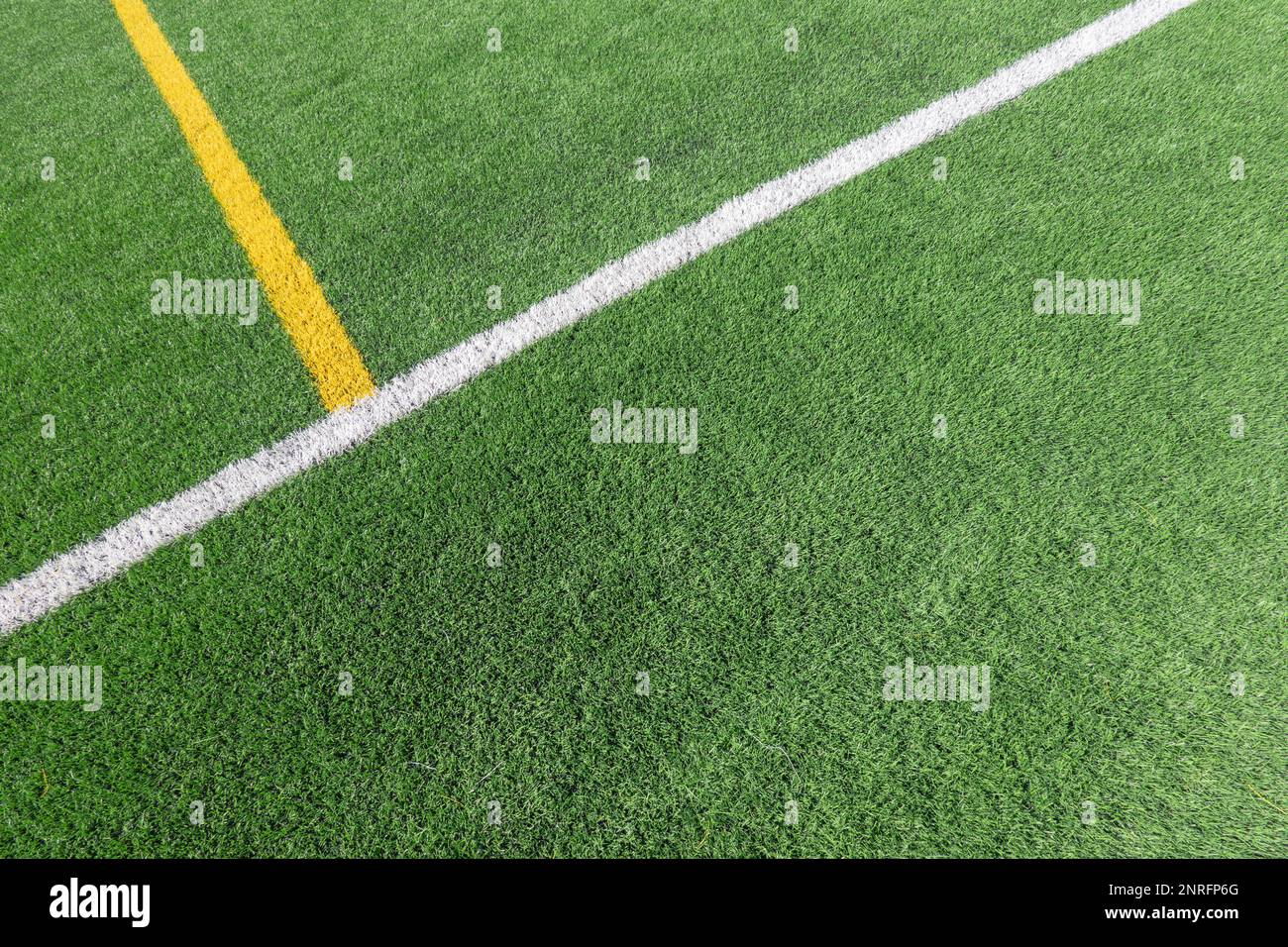 Green artificial grass turf soccer football field background with white ...