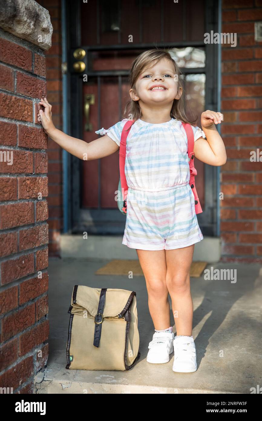 Excited young girl leaving for preschool Stock Photo - Alamy