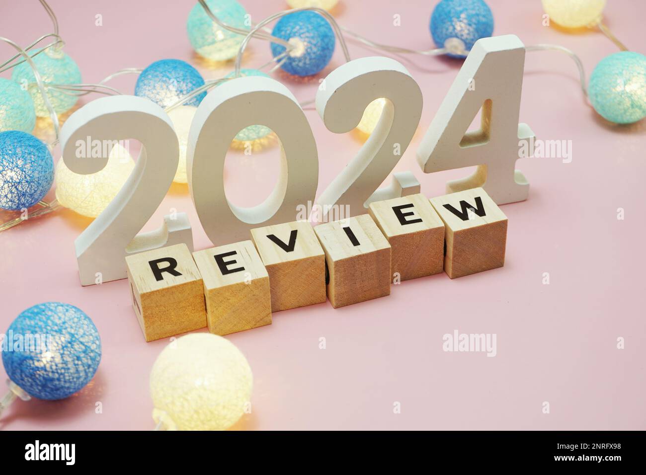 Review 2024 word alphabet letters on pink background Stock Photo - Alamy