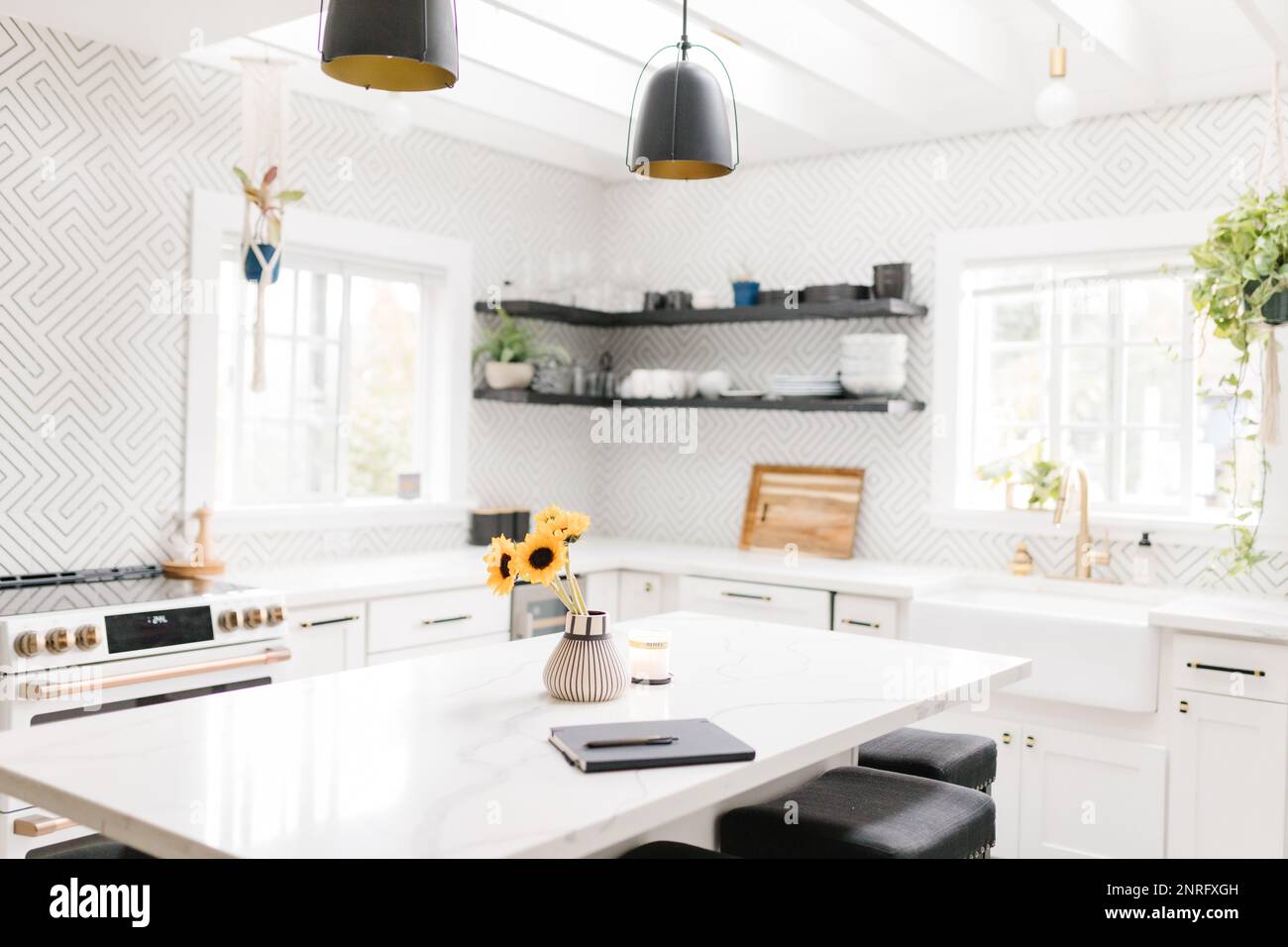 Bright white and black modern kitchen with notebook on counter Stock ...
