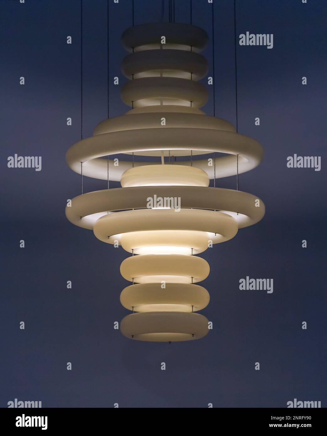 Modern ring-shaped light fixture in dark ambiance Stock Photo - Alamy