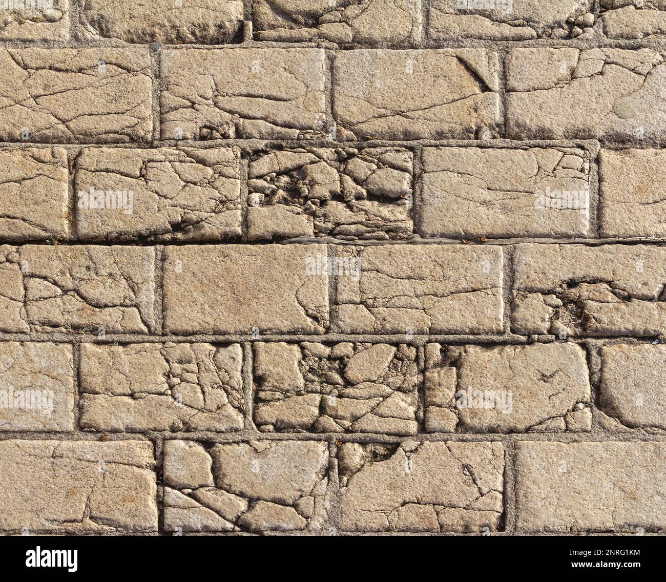 Full frame closeup shot showing a wall detail with partly broken bricks ...