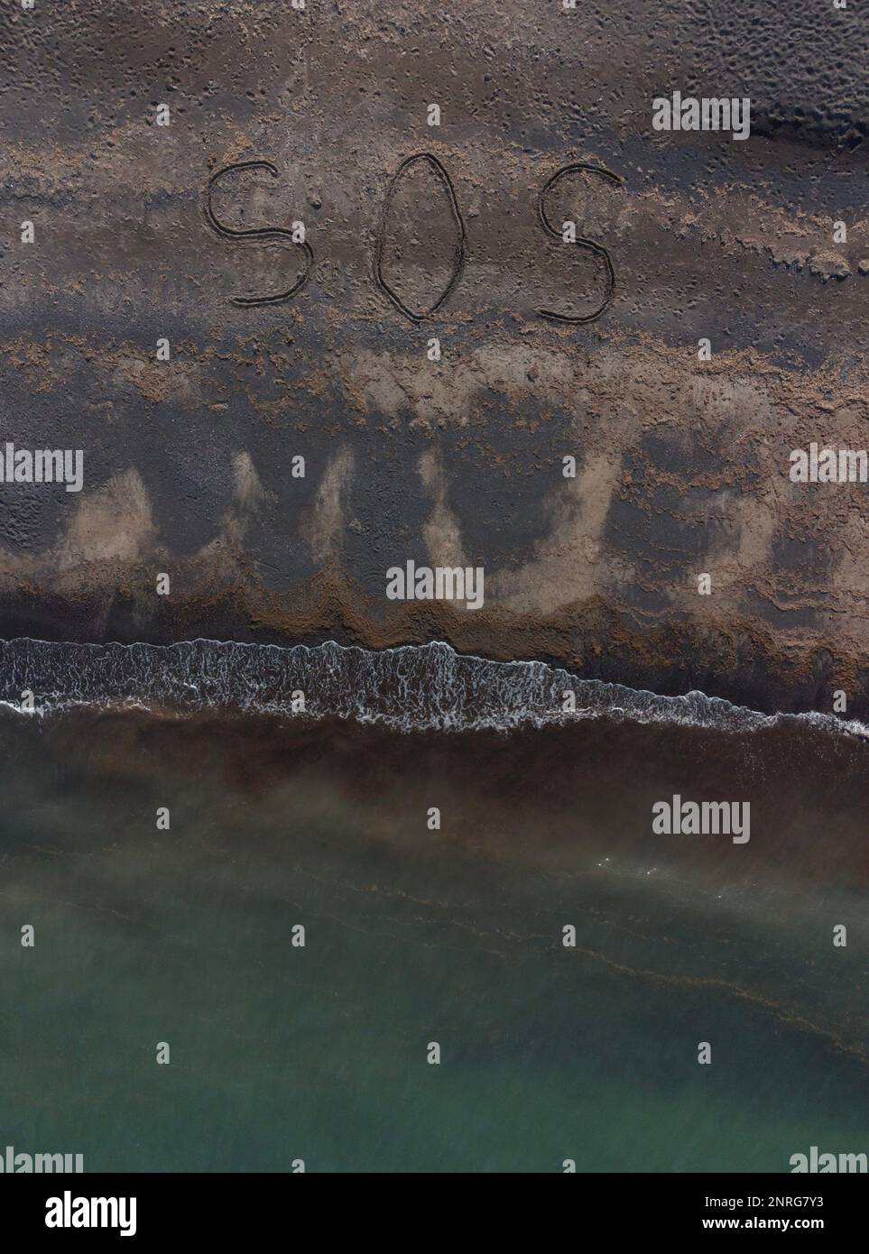 An aerial view of a volcanic beach in the Canary Islands with an SOS ...