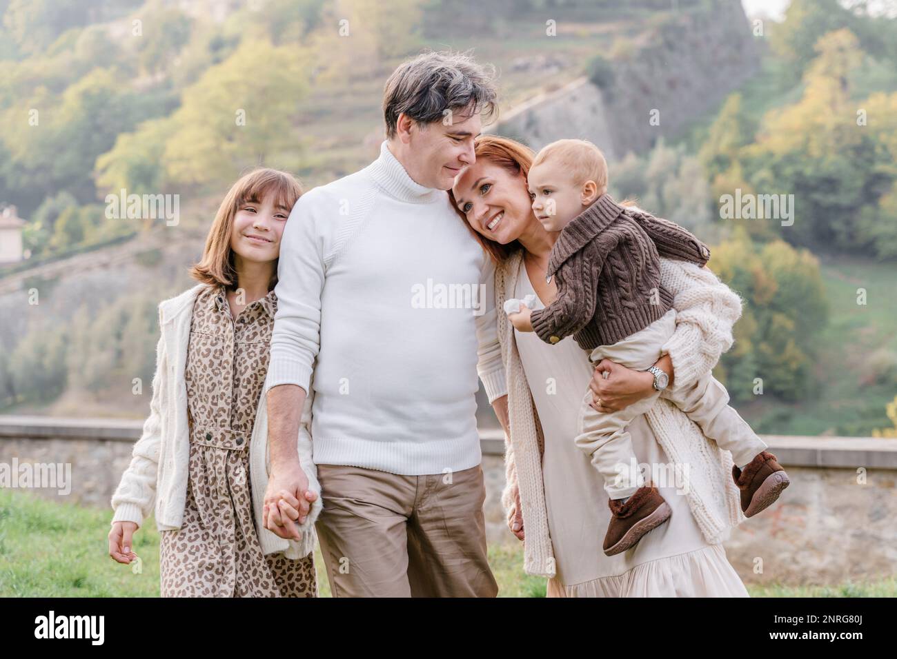 A happy family with two children in a view point of Bergamo, Italy ...