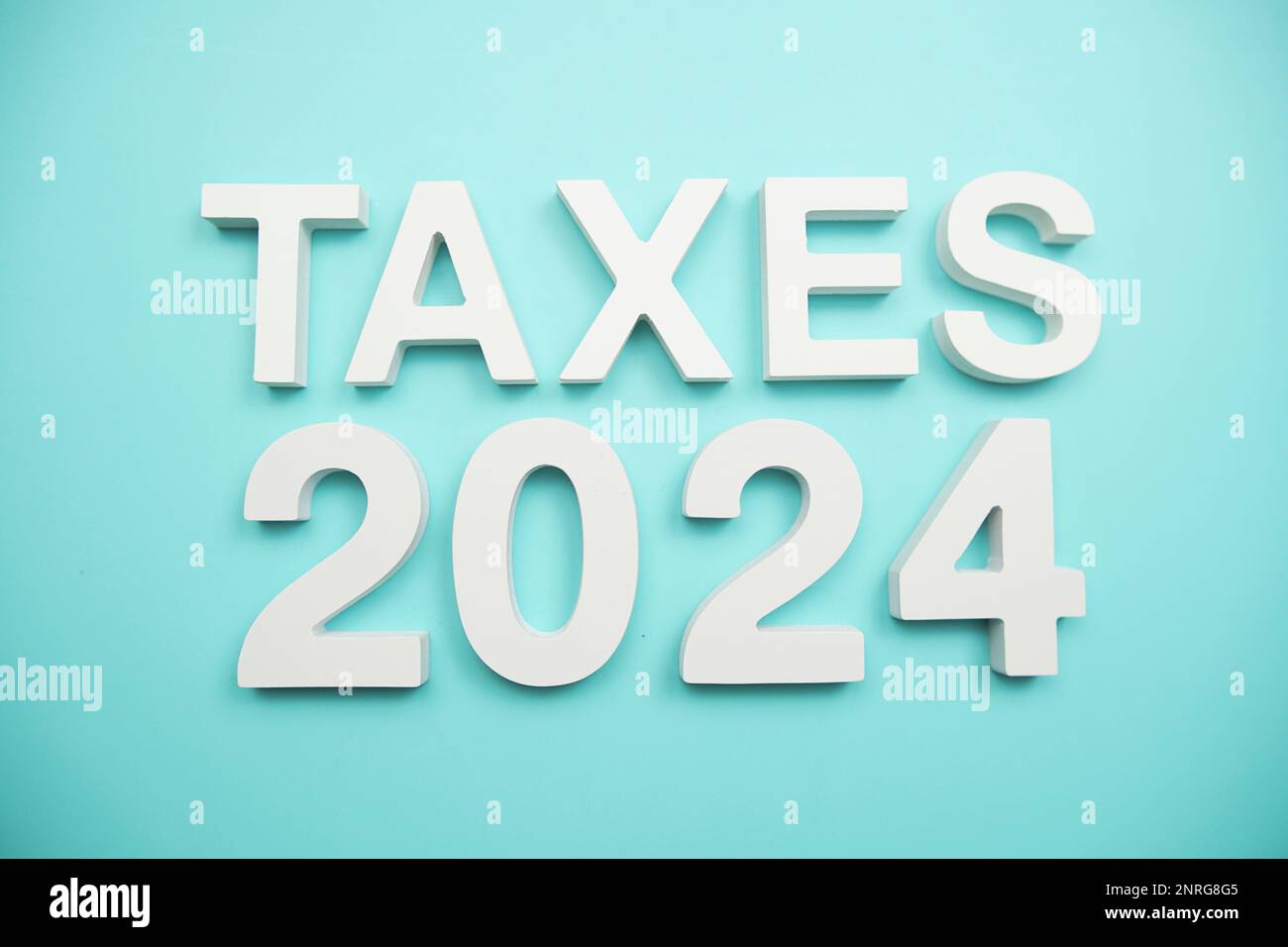 Taxes 2024 alphabet letters on blue background Stock Photo - Alamy