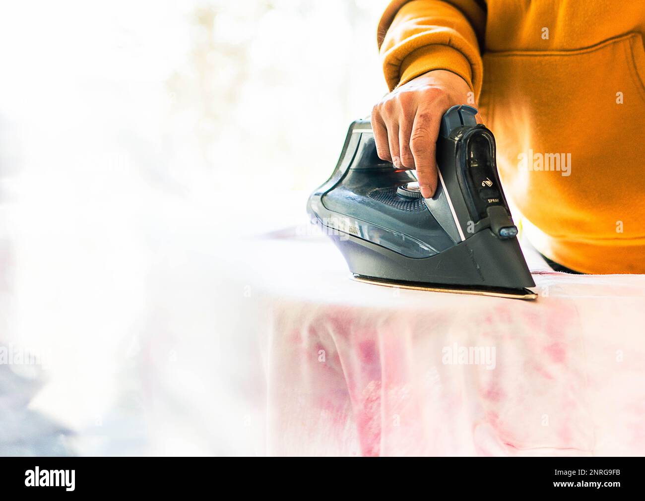 Female ironing clothes hi-res stock photography and images - Alamy