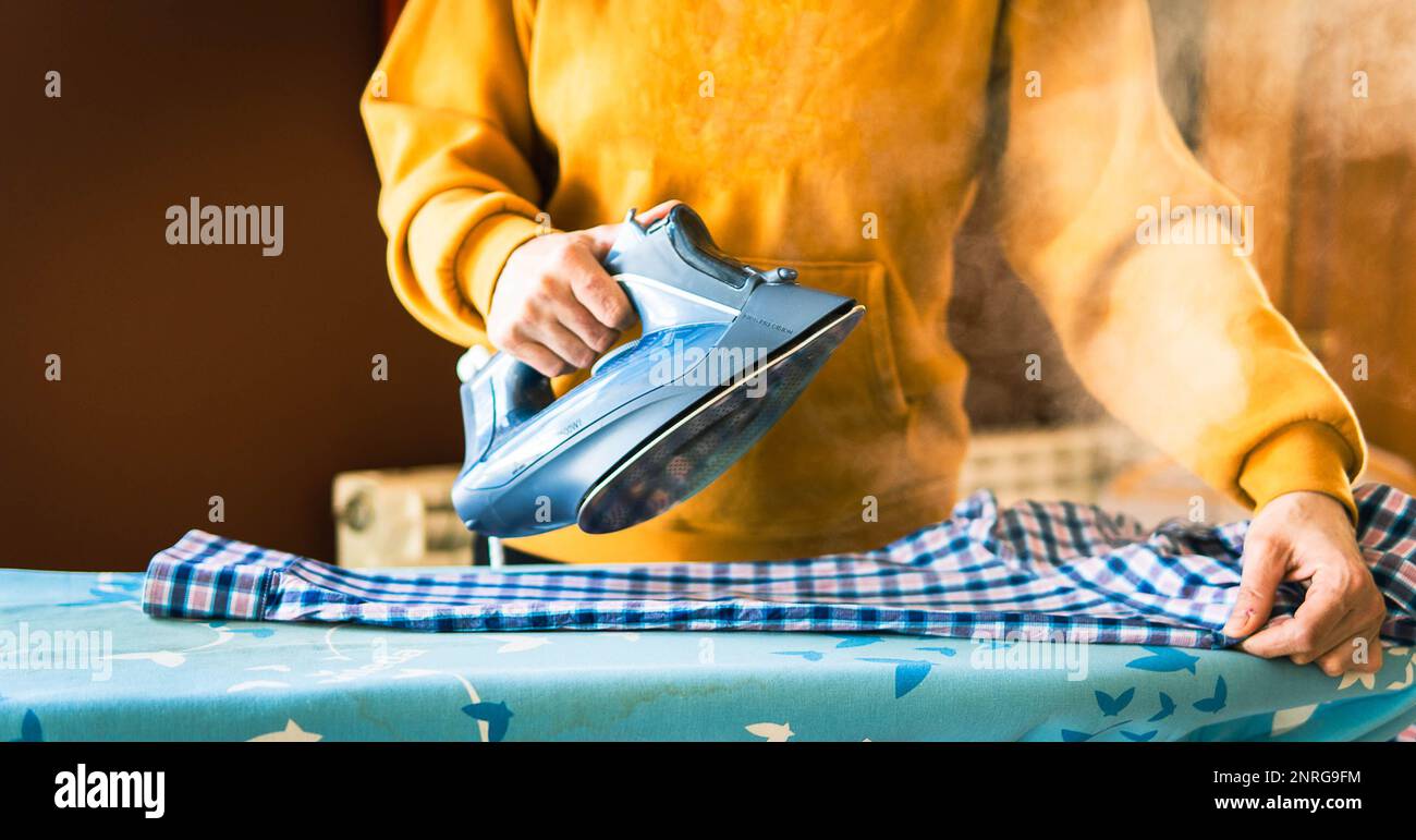 Old woman ironing clothes home hi-res stock photography and images - Alamy