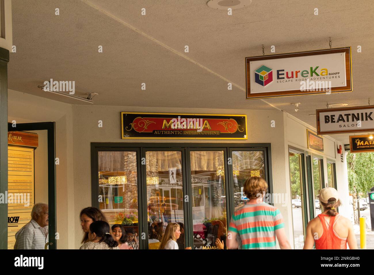A group of diverse individuals standing in front of a storefront with ...