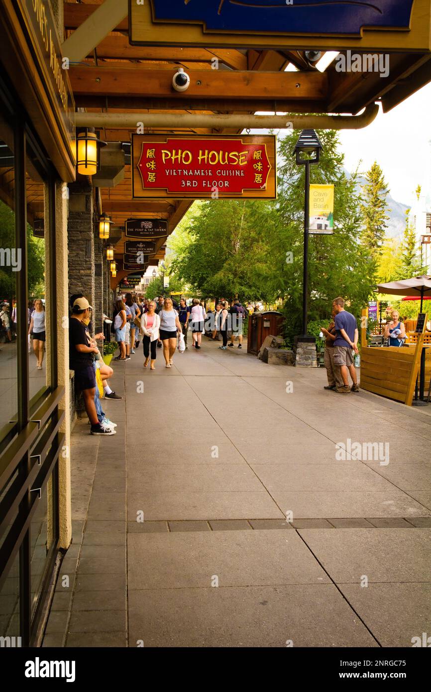 A group of diverse people walking down a busy city street in front of a ...