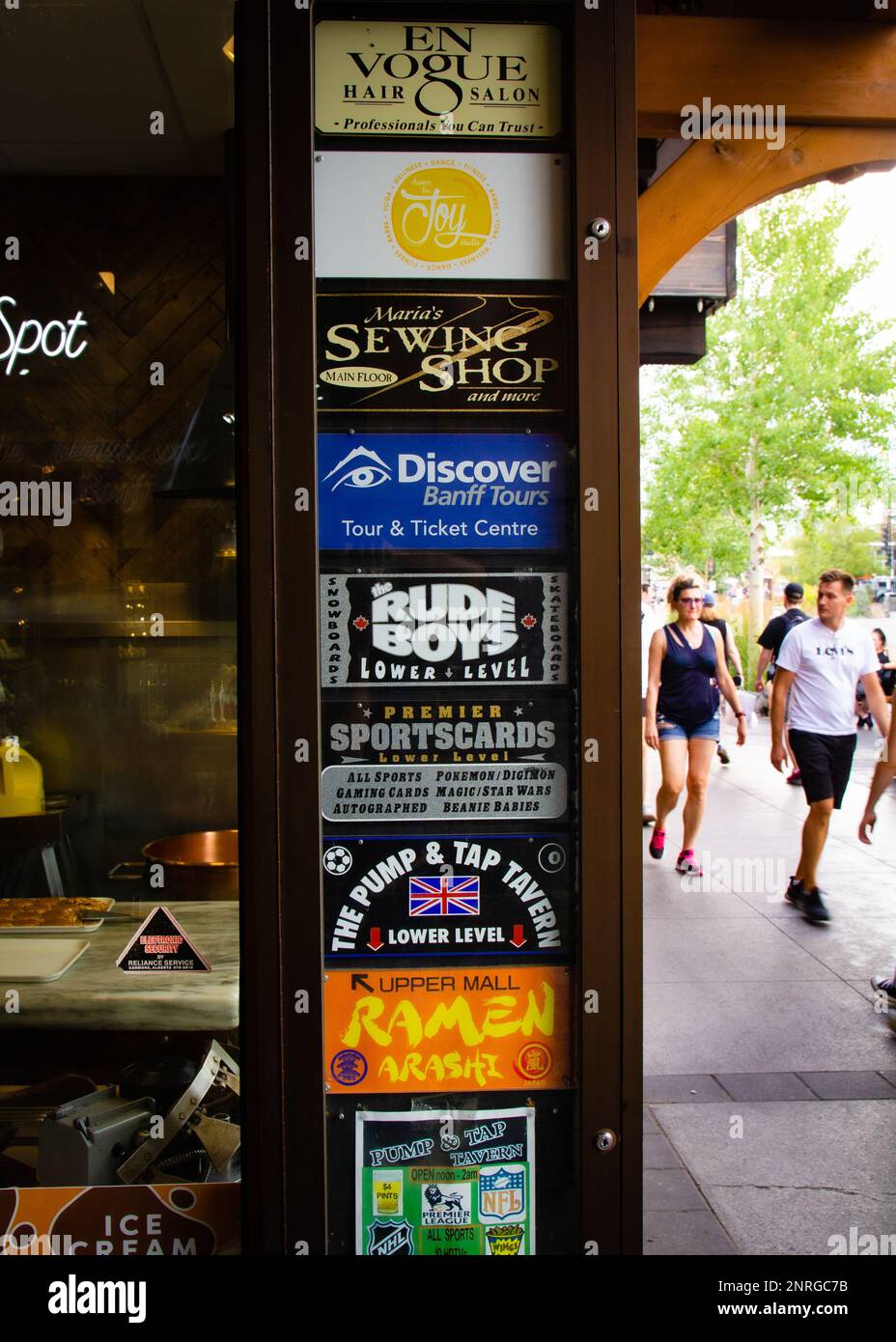 A window covered in colorful, eclectic signage, stickers and other ...