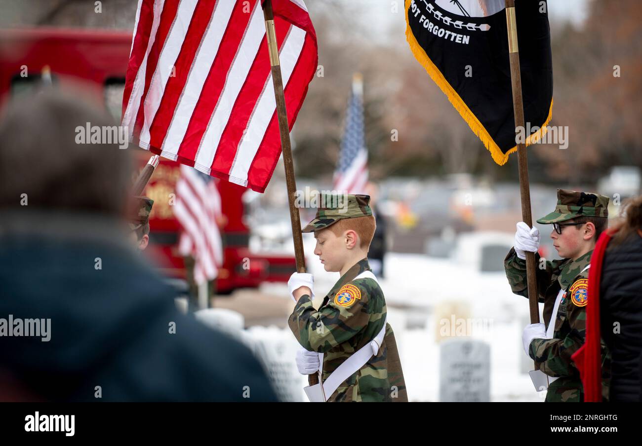 Members of the color guard carry the flags after the singing of the ...