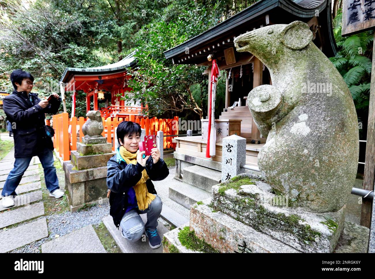 Visitors take pictures of a rat statue at Otoyo Jinja Shrine in Kyoto ...