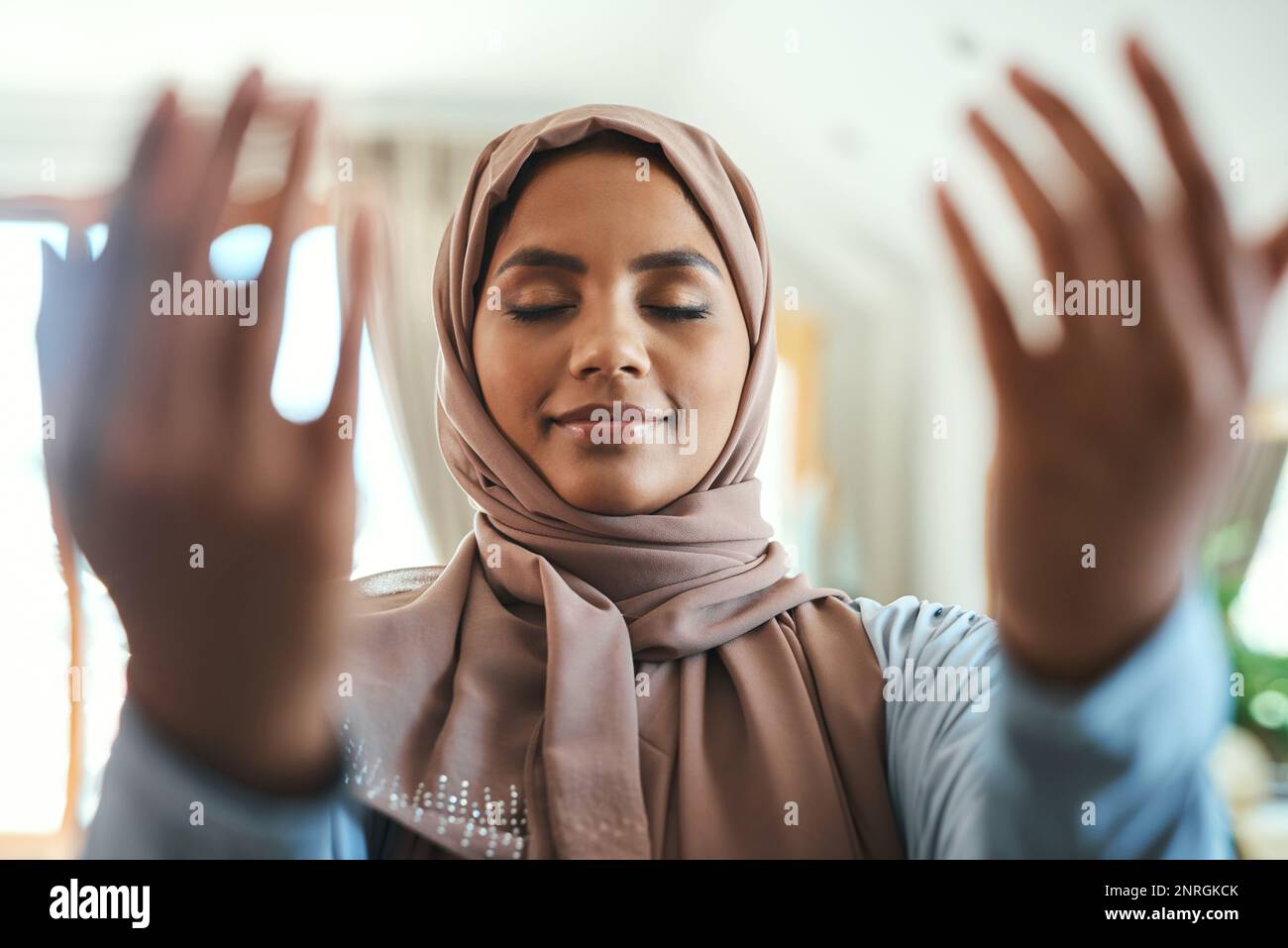 Just saying thank you. a young muslim woman praying in the lounge at ...