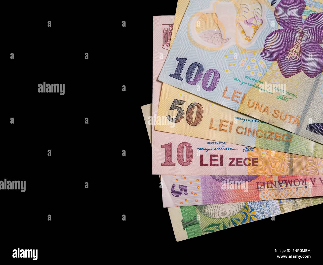 Many romanian banknotes on black background. Romanian currency concept ...