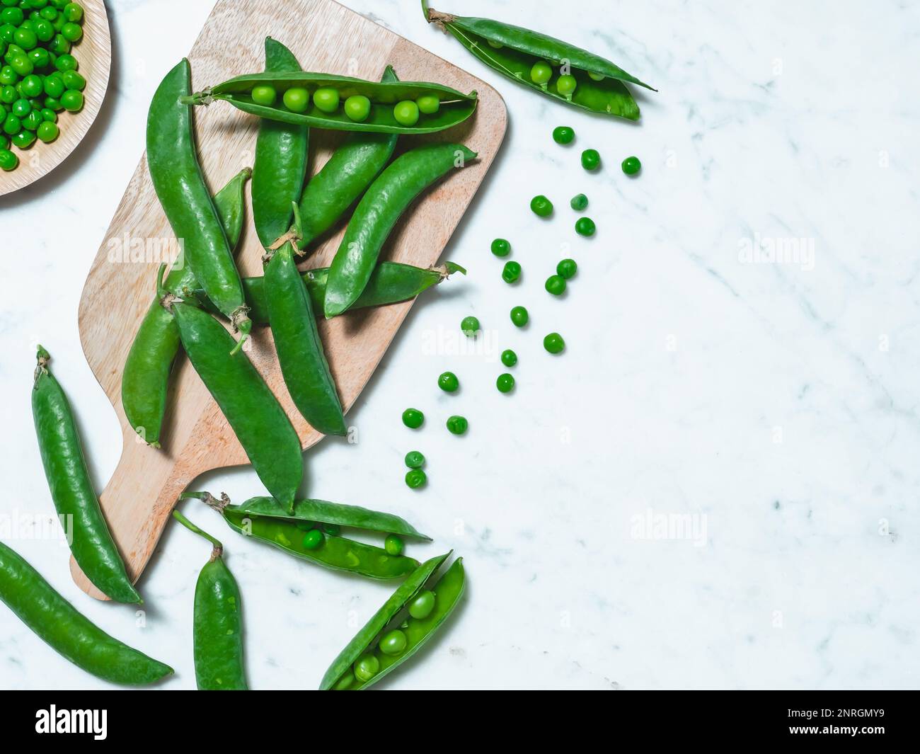 fresh green peas on withe background. top view of just harvest peas. Be ...