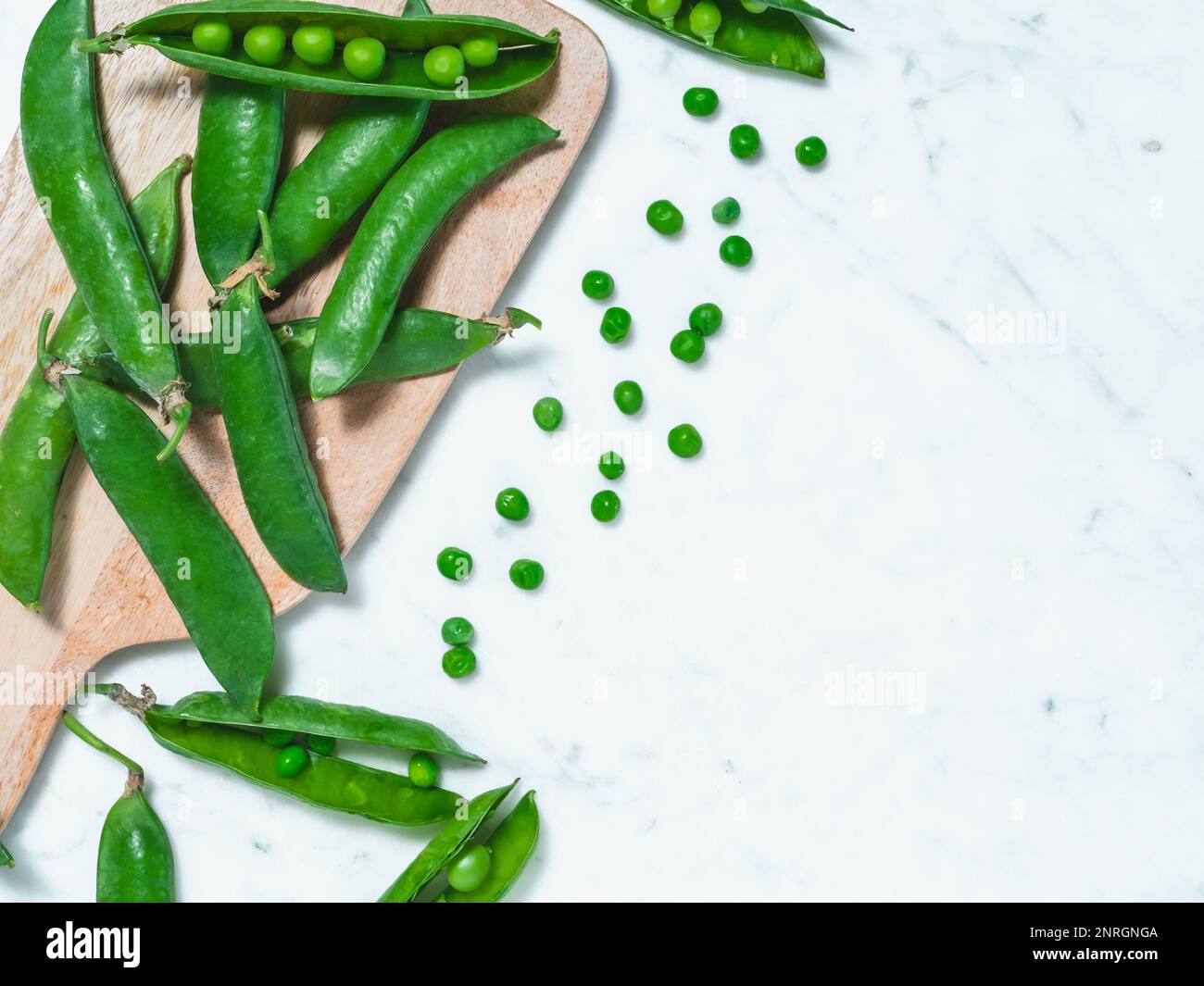 fresh green peas on withe background. top view of just harvest peas. Be ...