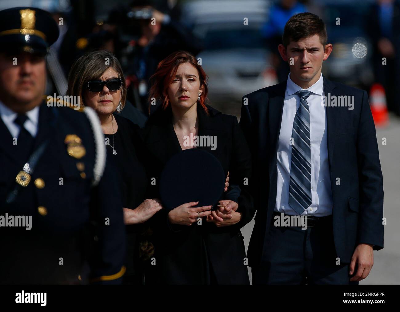 Bethany Elise Brewster, center, watches as the casket for her husband ...