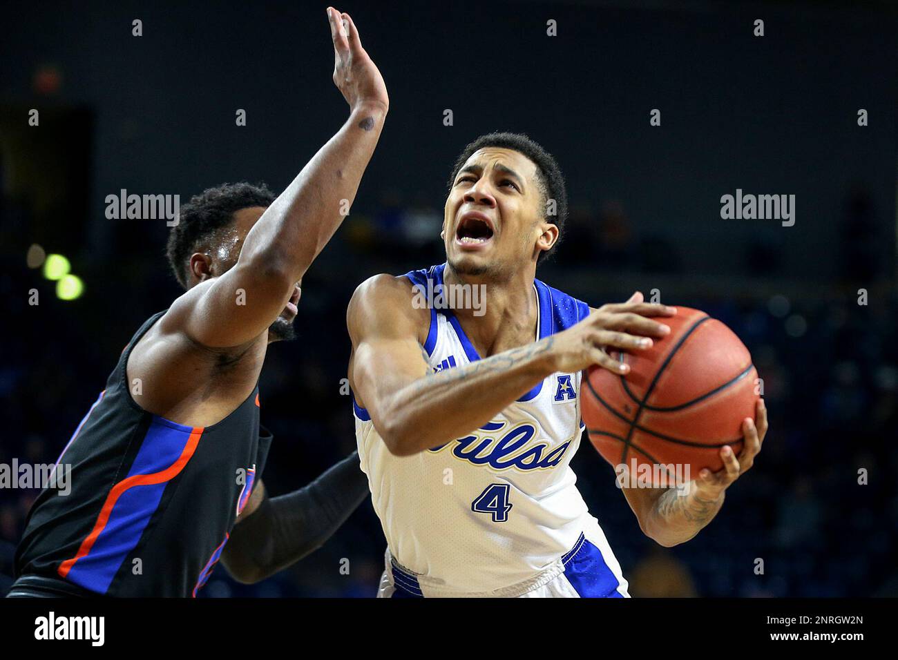 Tulsa guard Isaiah Hill (4) drives against Boise State guard Marcus ...