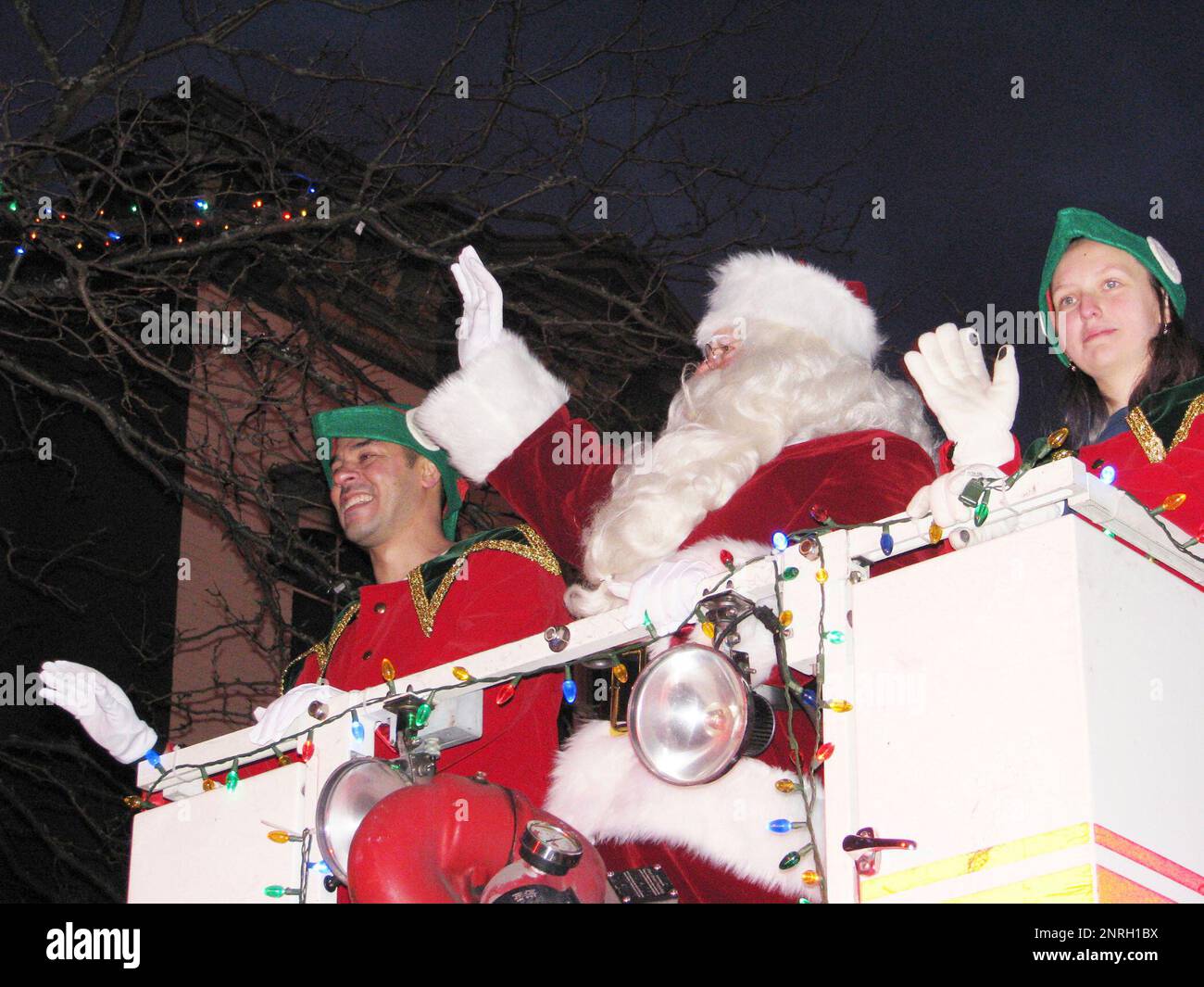 Santa Claus and his elves wave to the crowd from atop a Michigan City ...