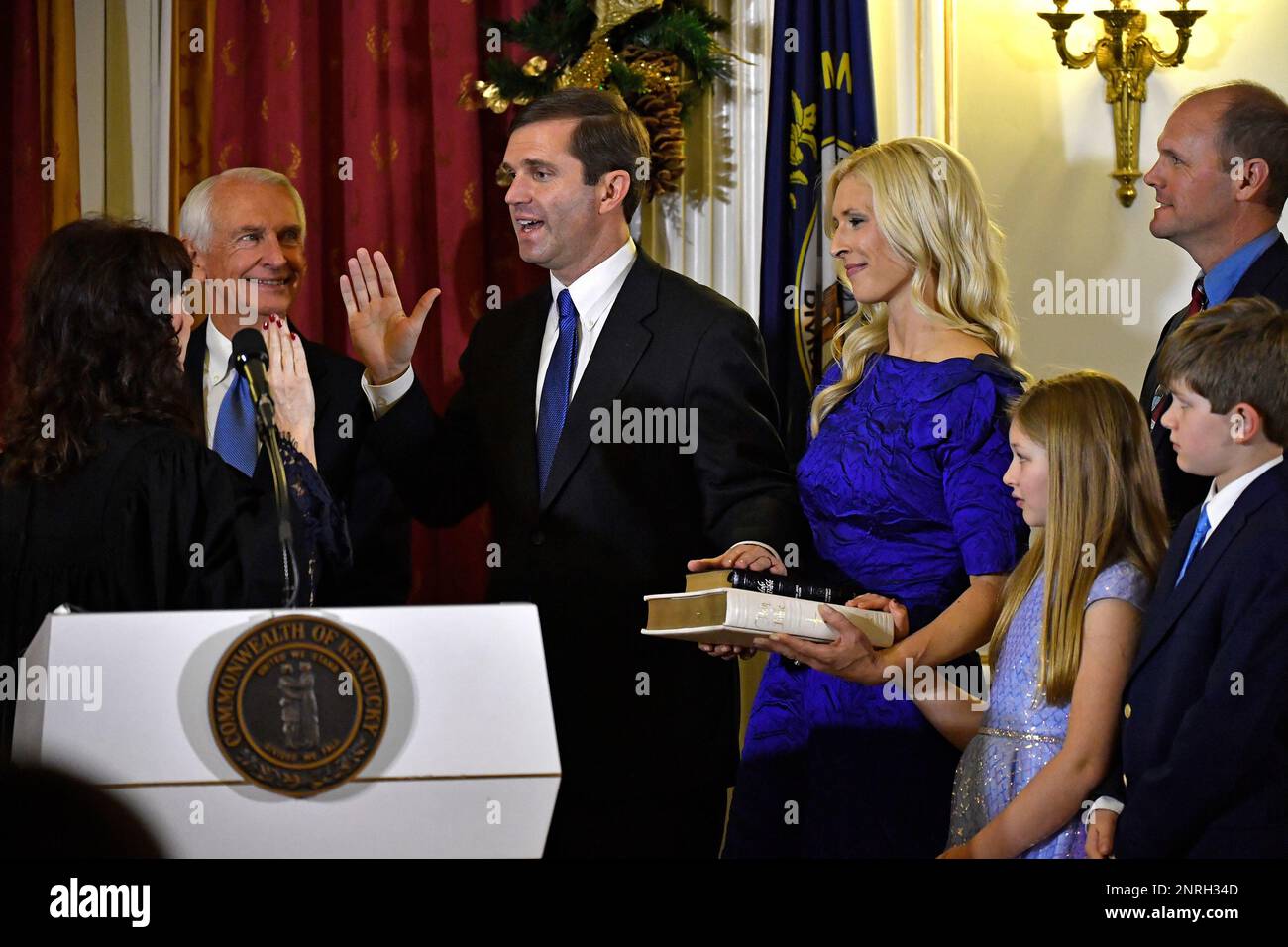 Andy Beshear raises his hand as his wife, Britainy Beshear, holds the ...