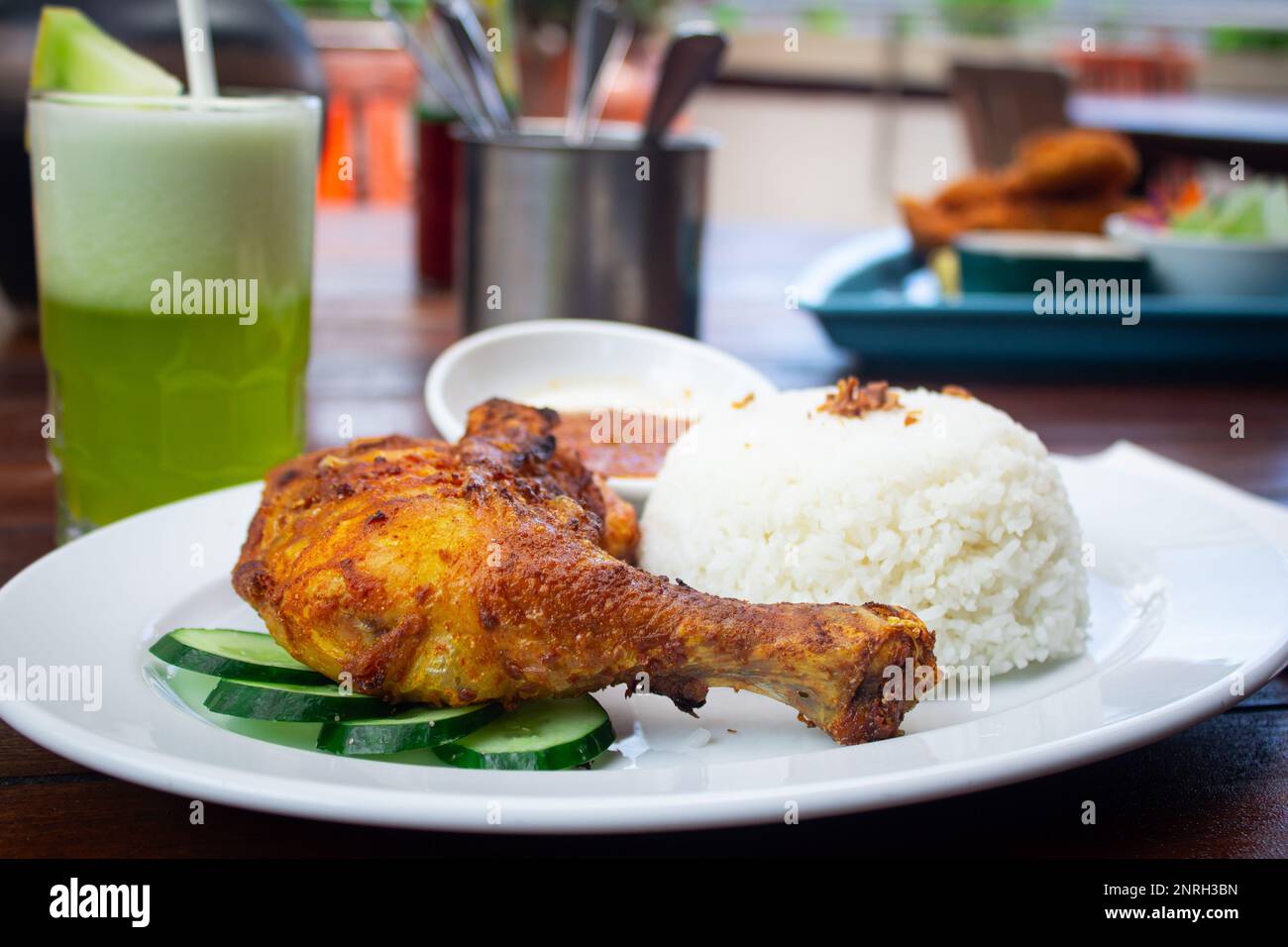 A traditional Malaysian food nasi lemak consisting of fried chicken ...