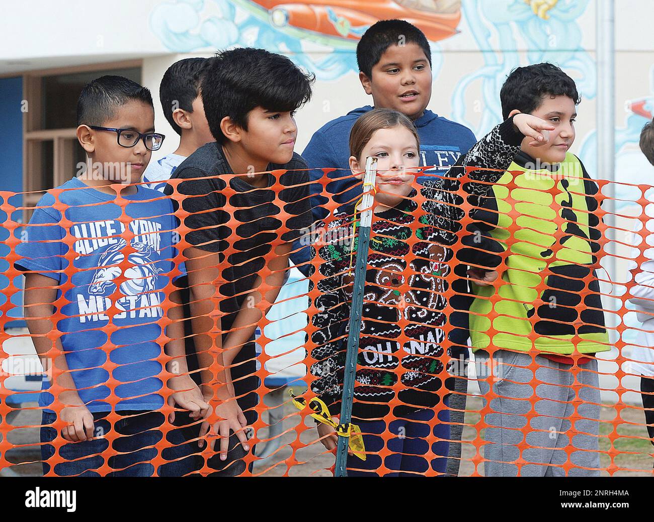 Alice Byrne Elementary School students pause during their recess to ...