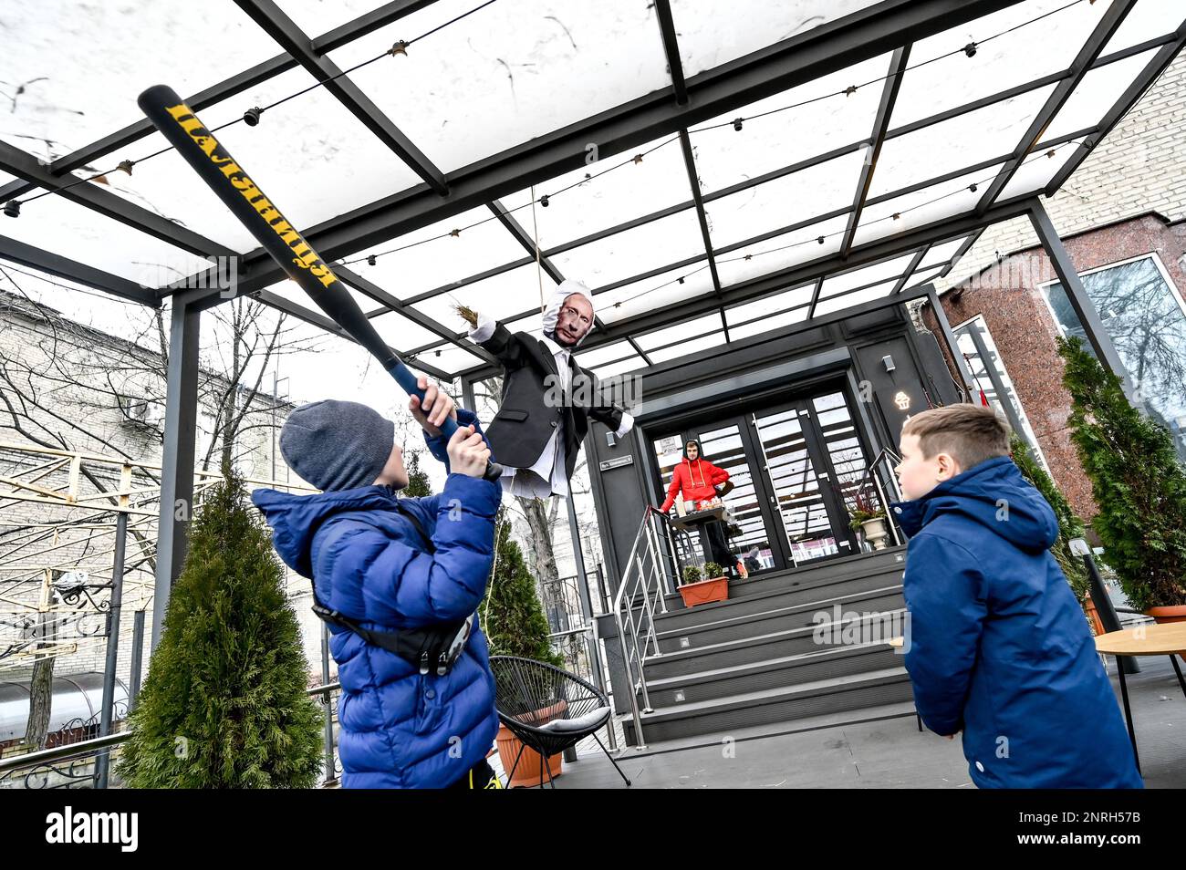 ZAPORIZHZHIA, UKRAINE - FEBRUARY 26, 2023 - A boy hits an effigy of ...