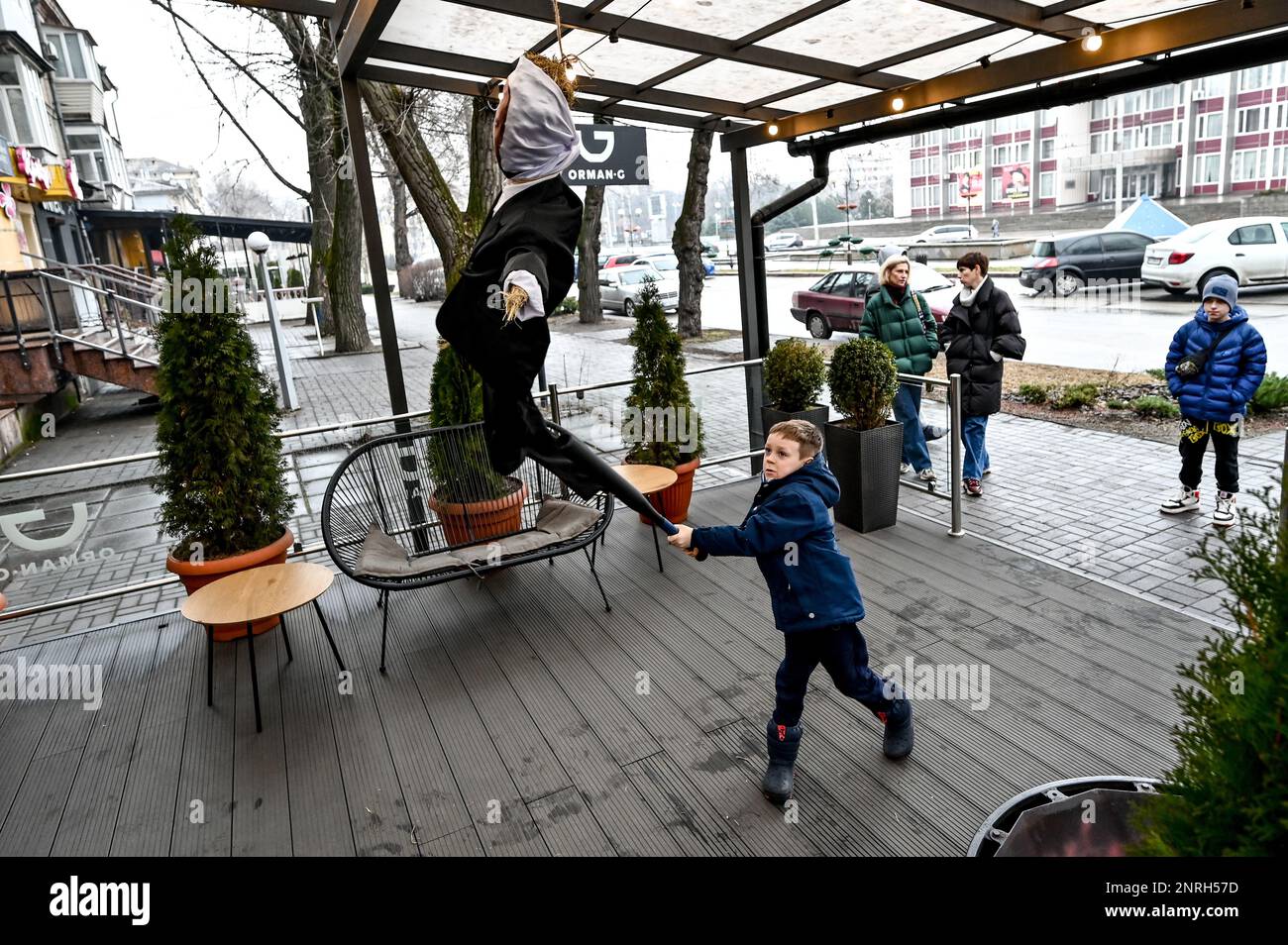 ZAPORIZHZHIA, UKRAINE - FEBRUARY 26, 2023 - A boy hits an effigy of ...