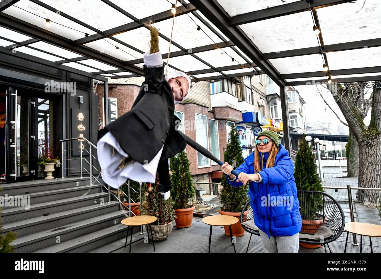 ZAPORIZHZHIA, UKRAINE - FEBRUARY 26, 2023 - A woman hits an effigy of ...