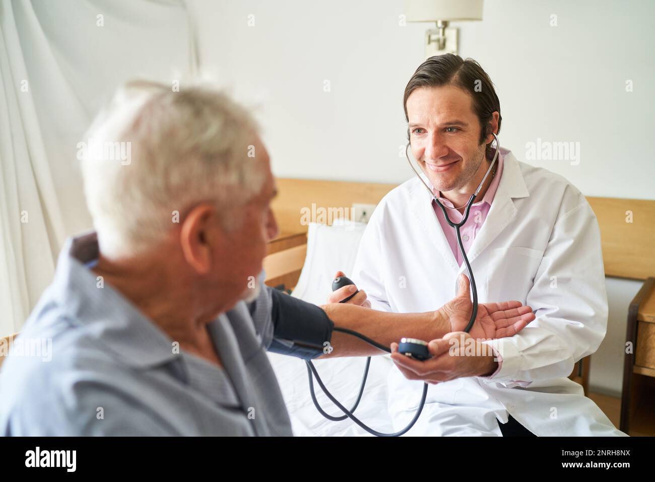 Doctor checking pulse on patient hi-res stock photography and images ...