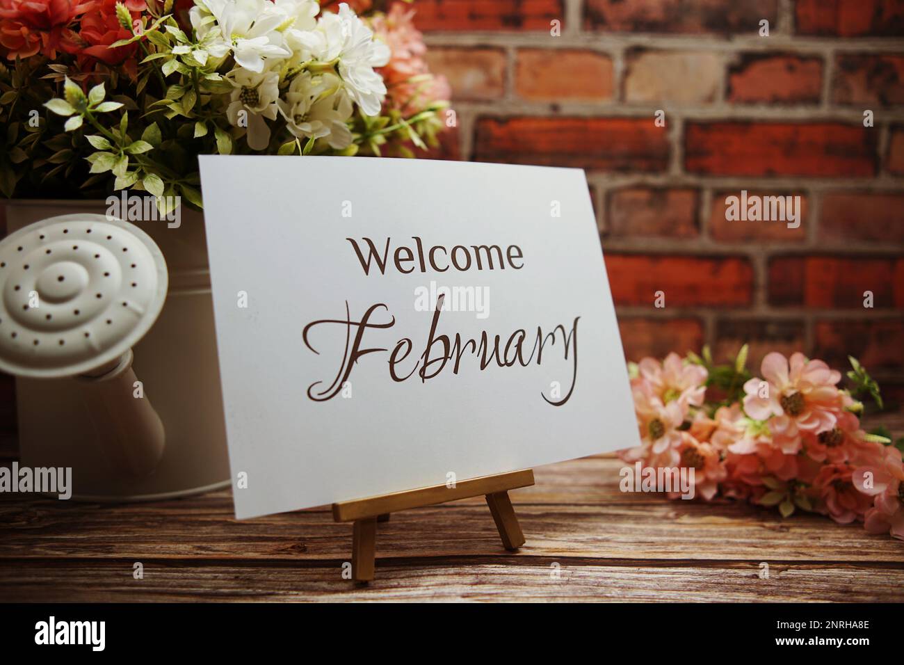 Welcome February text with flower bouquet decoration on wooden and old ...