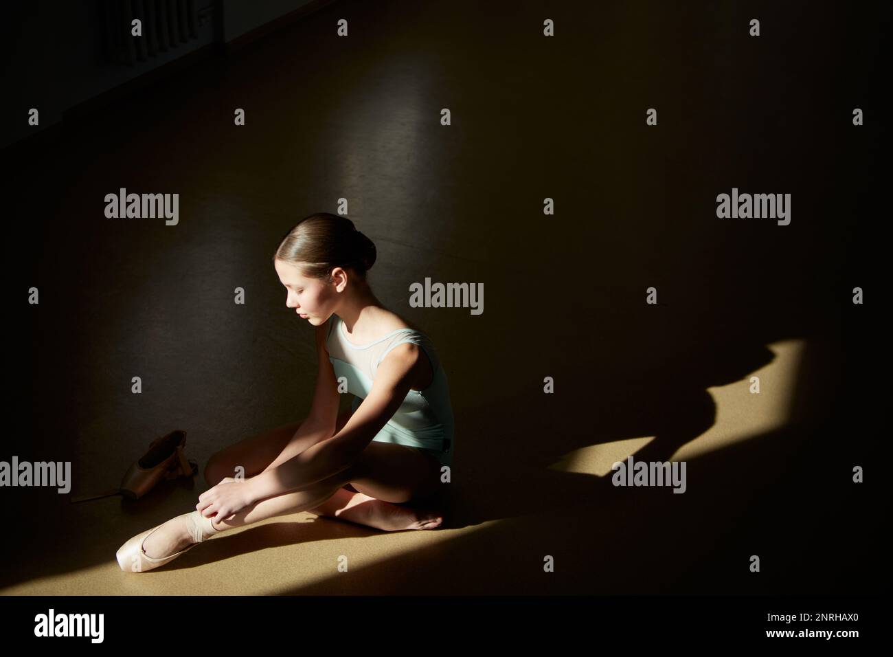 Tender teen girl, classical ballet dancer getting ready to train in ...