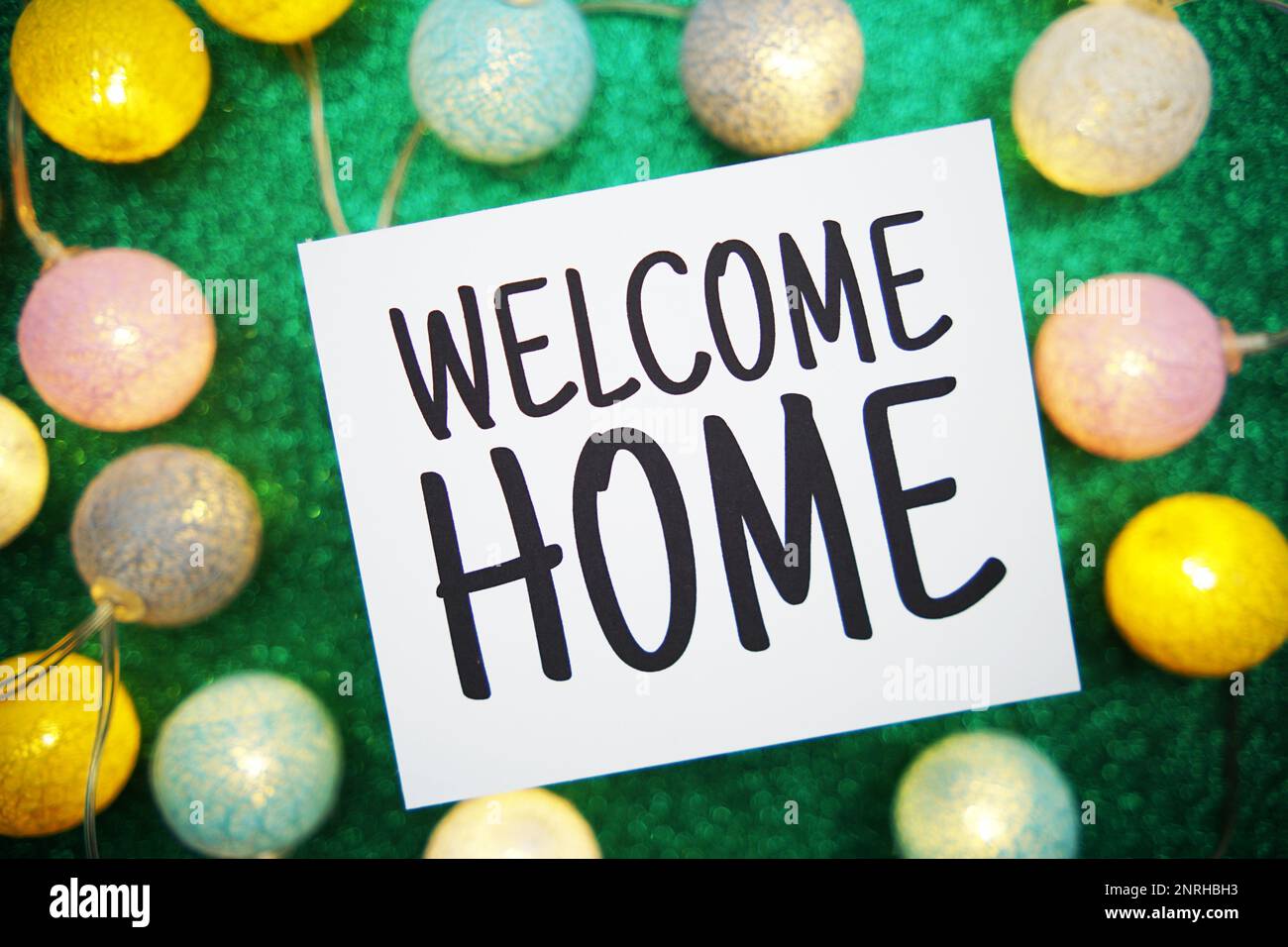 Welcome Home text on paper card with LED cotton balls decoration on ...