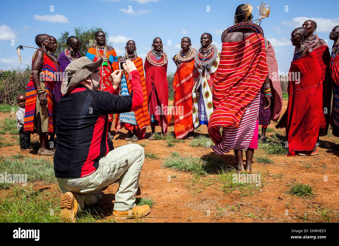 Tourist taking pictures, group of Masai women doing a traditional dance ...