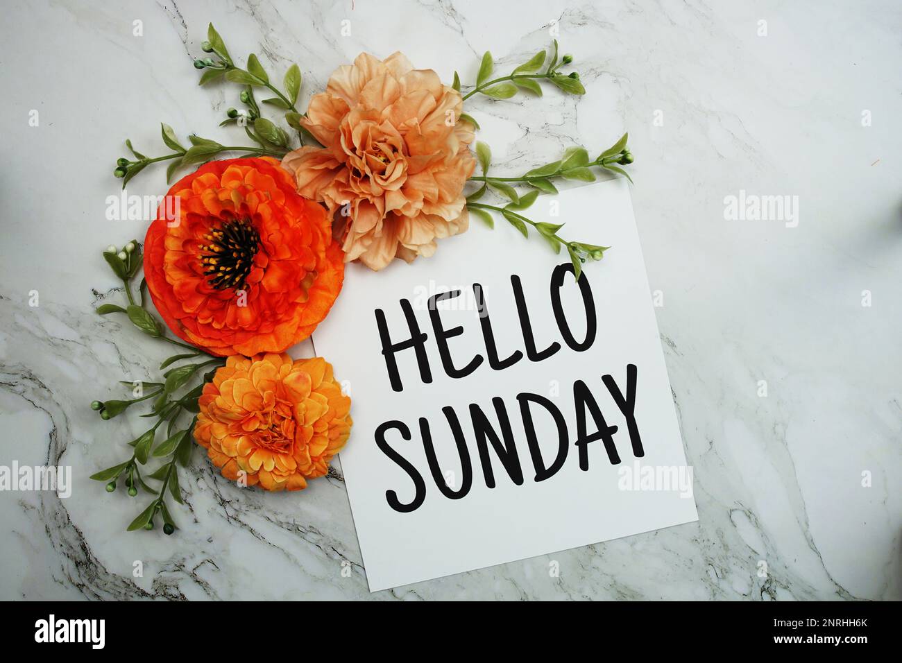 Hello Sunday text with orange flower bouquet on marble background Stock ...