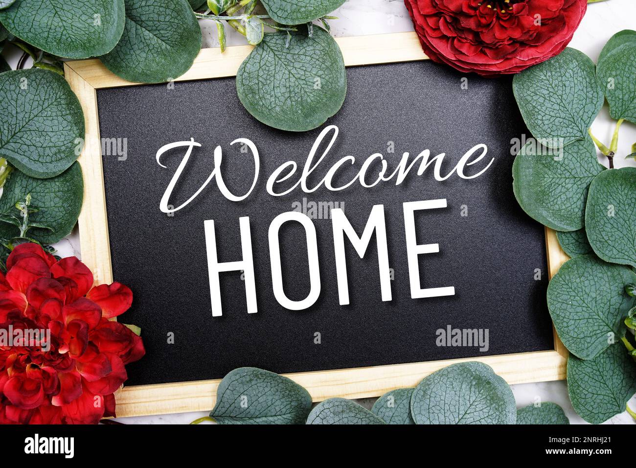 Welcome Home text on blackboard and eucalyptus leaves decoration on ...