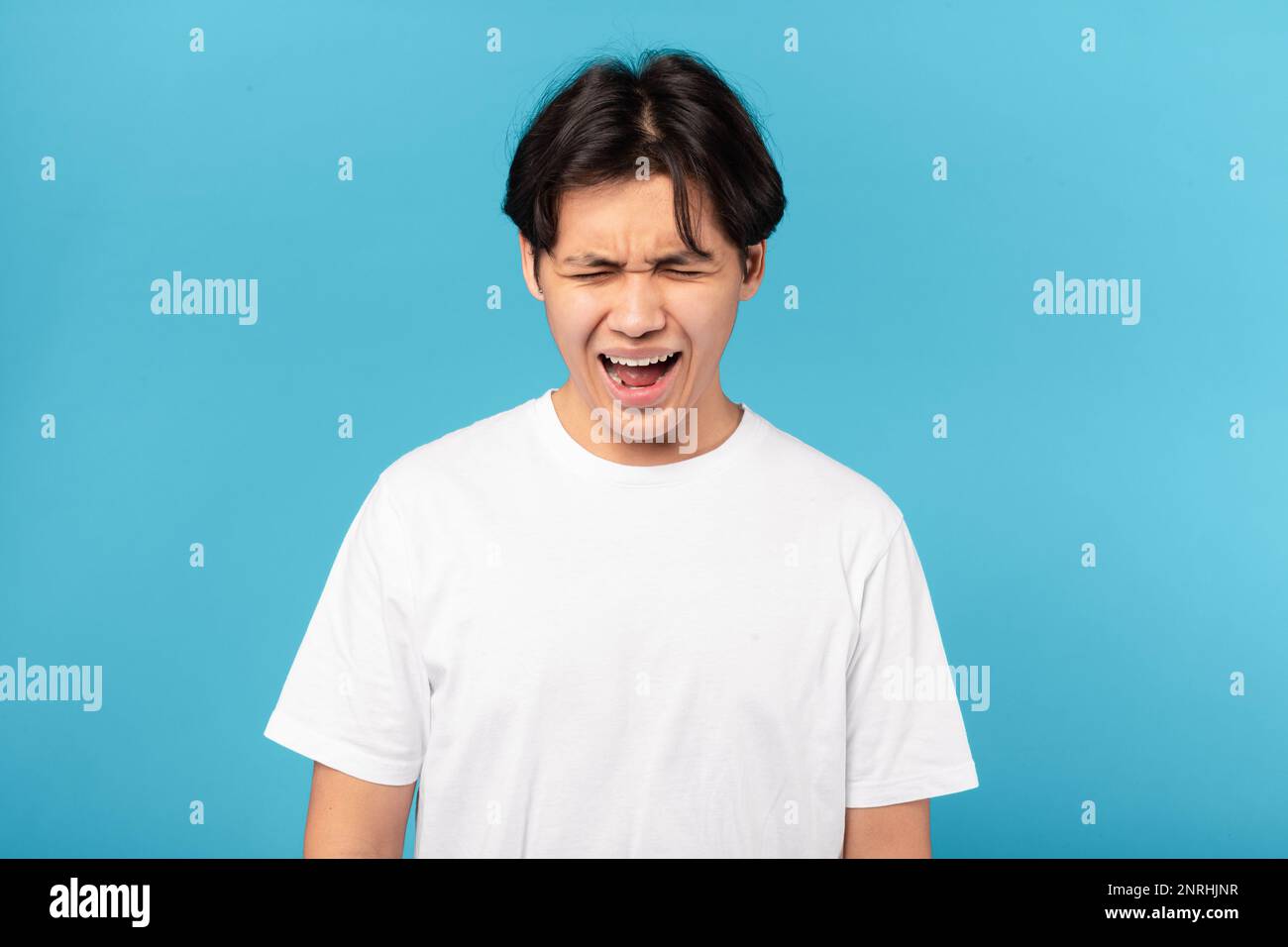 Sad Asian Teen Guy Shouting Loudly Crying Over Blue Background Stock ...