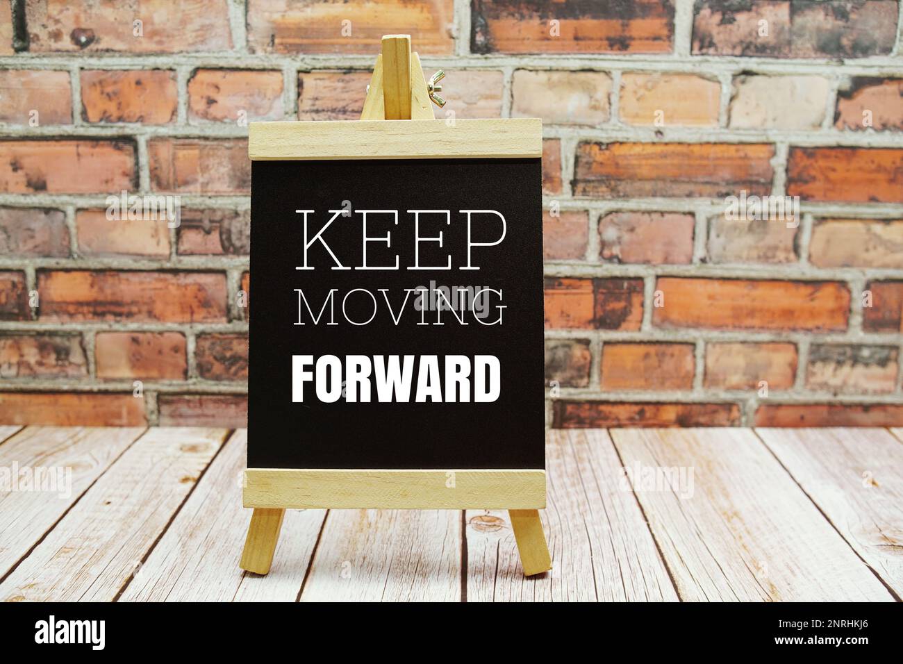 Keep Moving Forward typography text on the blackboard set on wooden ...
