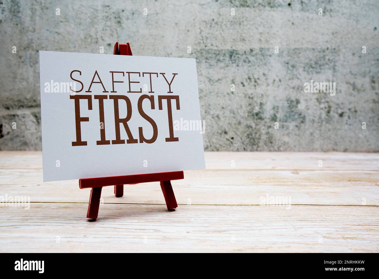 Safety First text on paper card on wooden background Stock Photo - Alamy