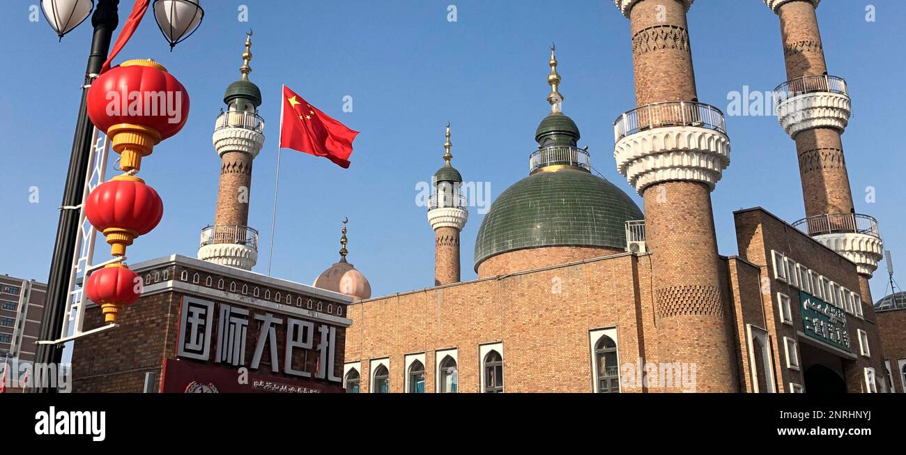 China's national flag is set near a mosque in Urumqi, the capital of ...