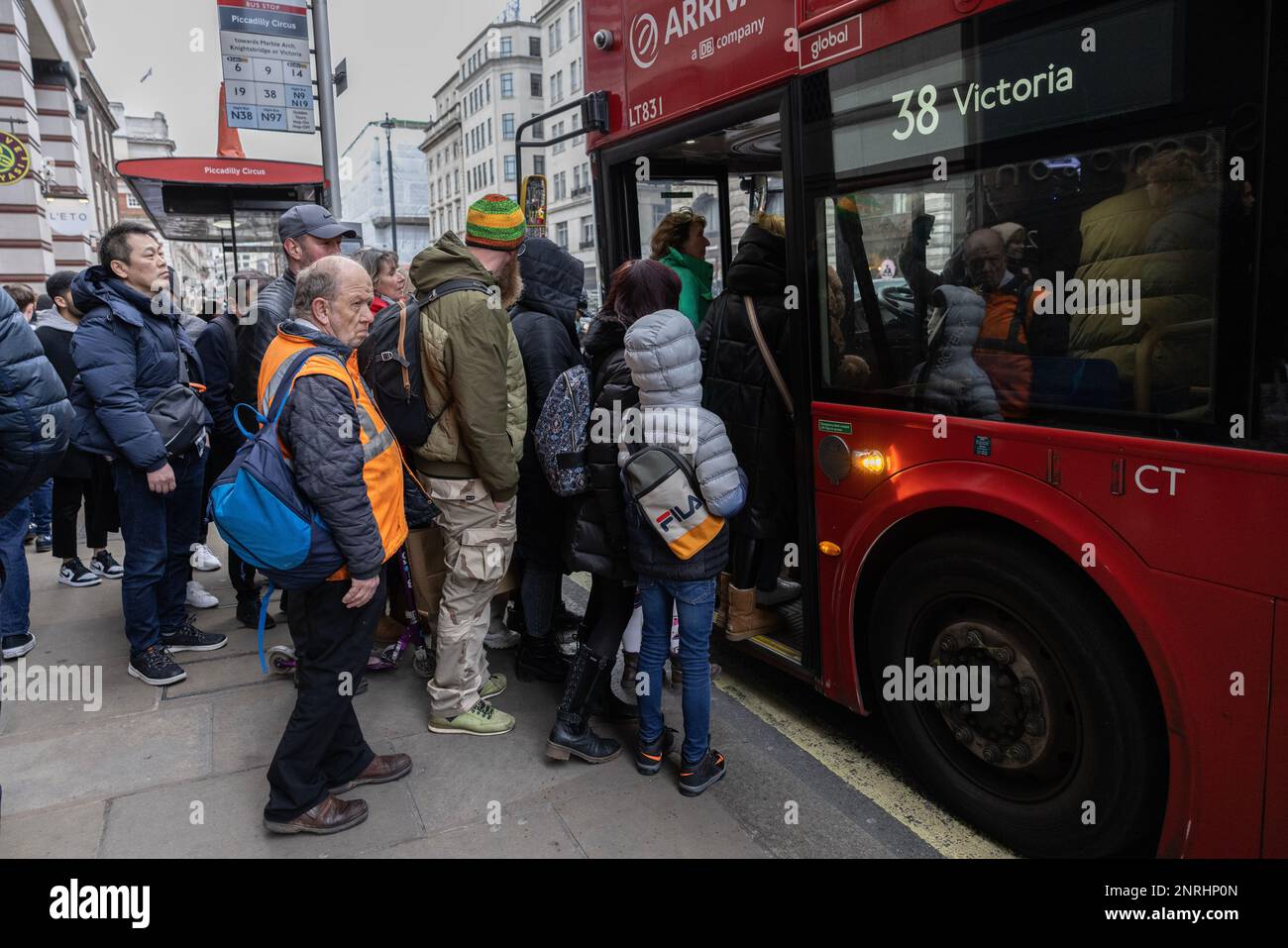 People queue to board an Arriva Routemaster n.38 bus on Piccadilly ...