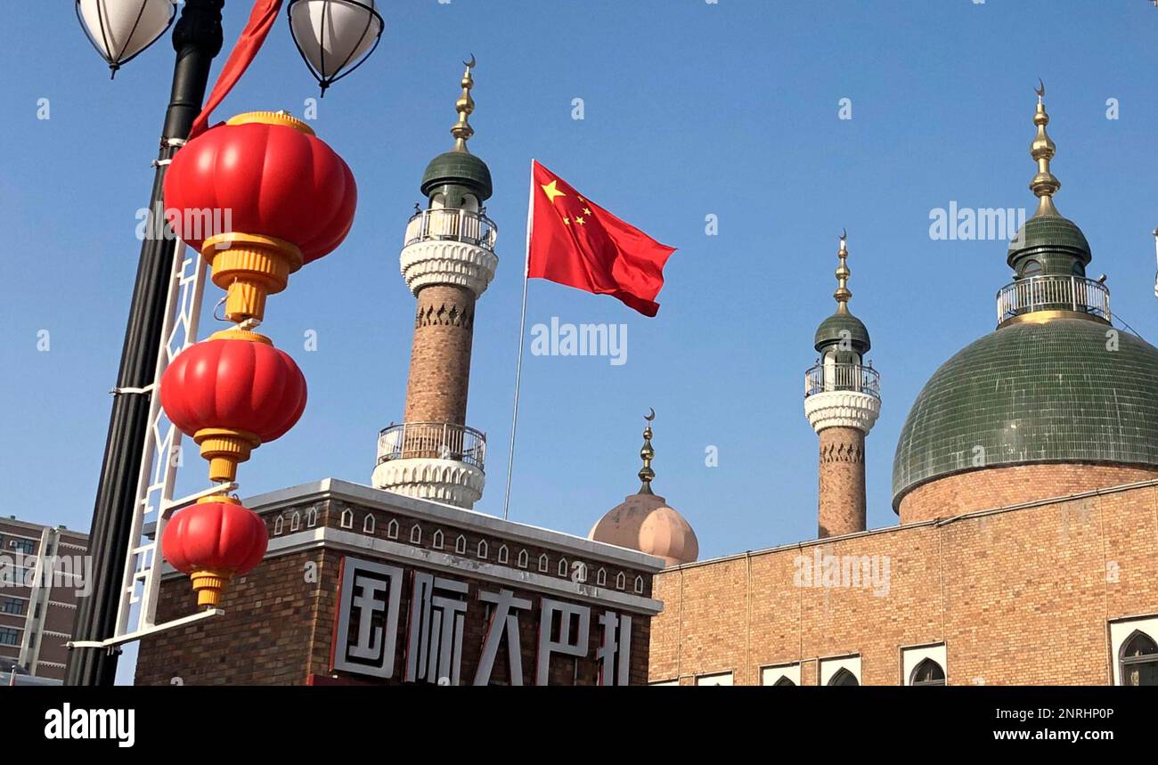 China's national flag is set near a mosque in Urumqi, the capital of ...