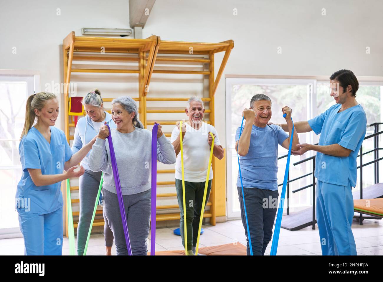 Group of happy elderly people doing workout in fitness class with ...