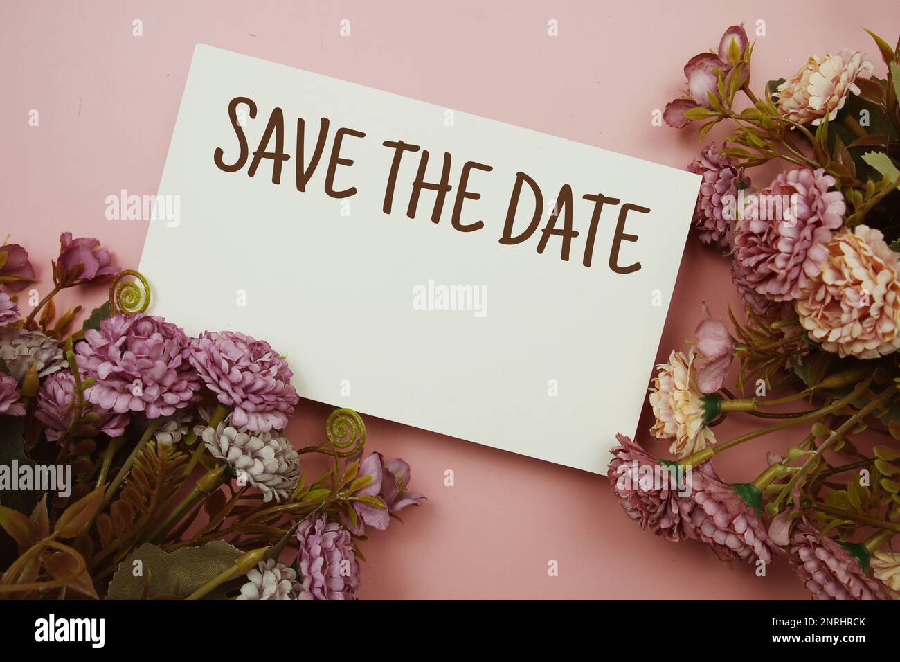 Save the Date typography text with flowers on pink background Stock ...
