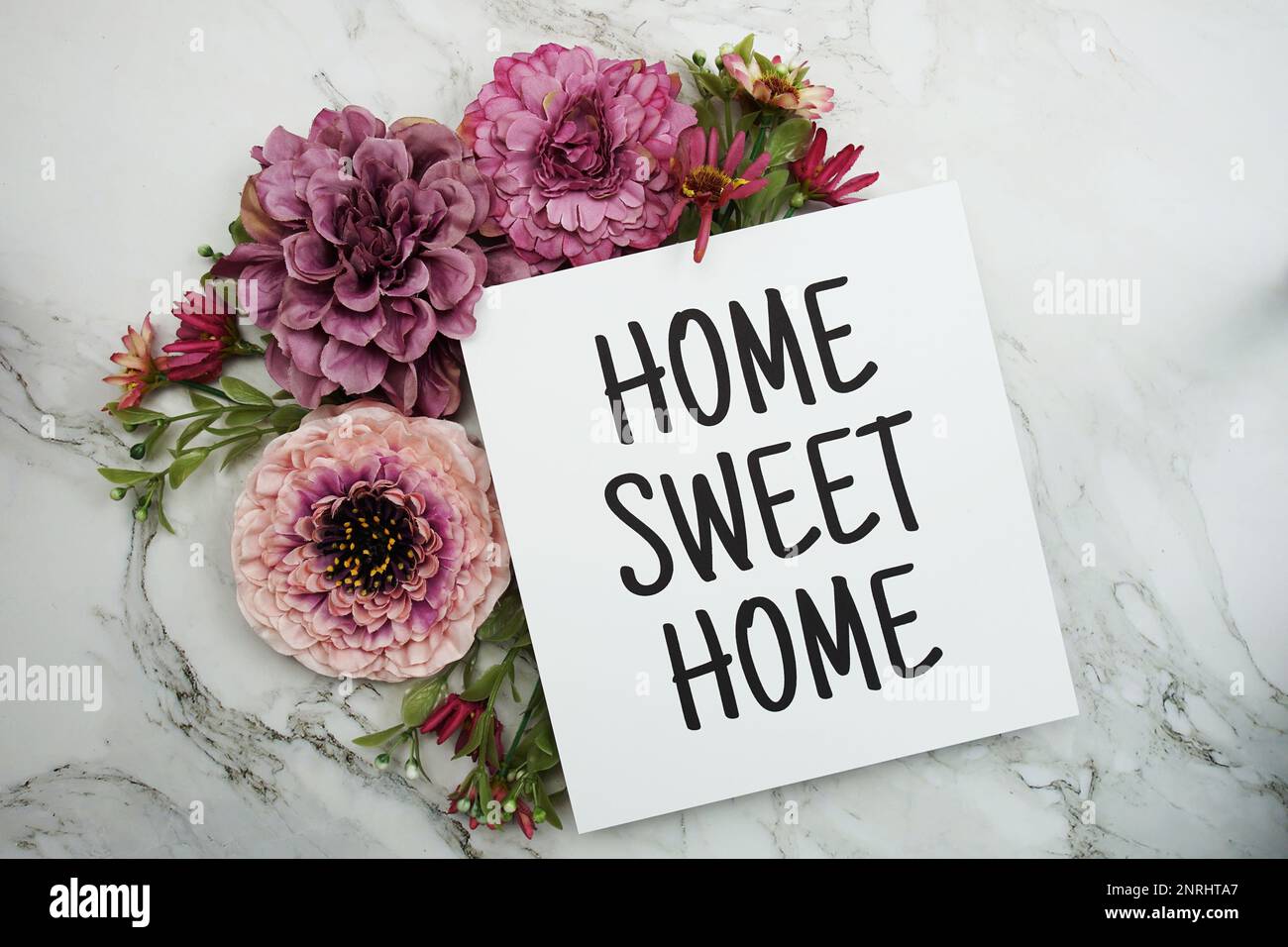Home Sweet Home text with pink flower bouquet on marble background ...