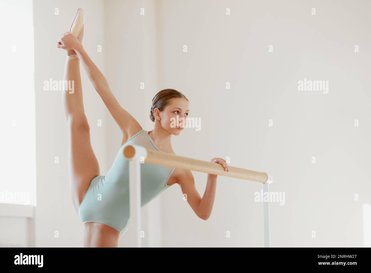 Flexibility and grace. Beautiful teen girl, ballet dancer training at ...