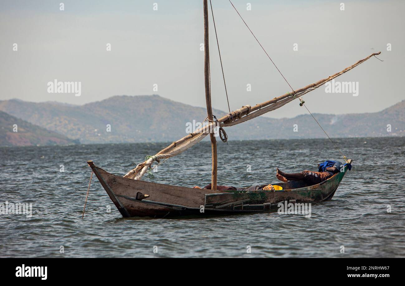 Boat with fisherman sleeping, near Rusinga Island, Lake Victoria, Kenya ...